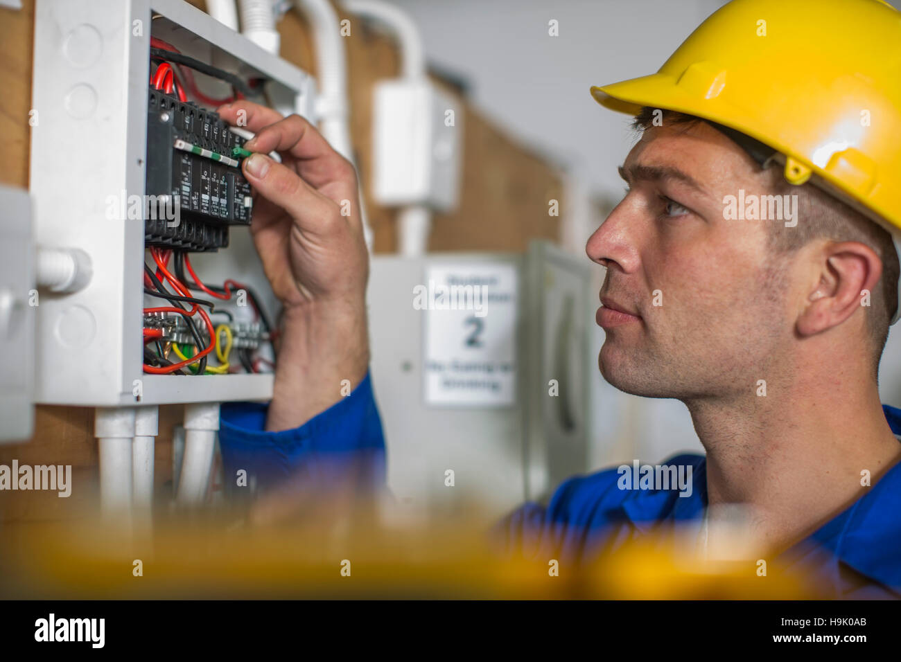 Electrician working on electrical panel Stock Photo - Alamy