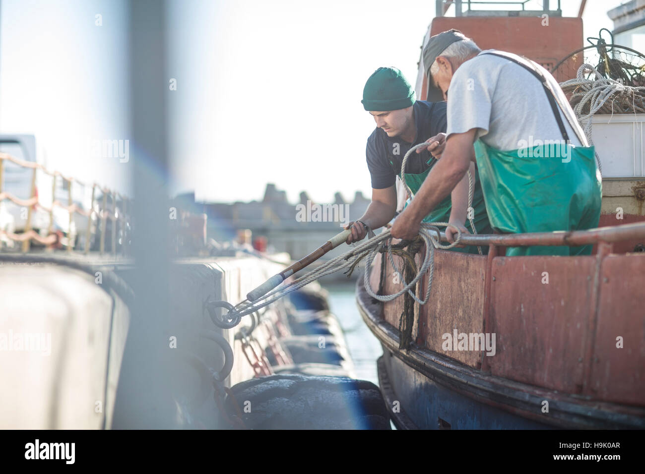Fishermen working on trawler Stock Photo - Alamy