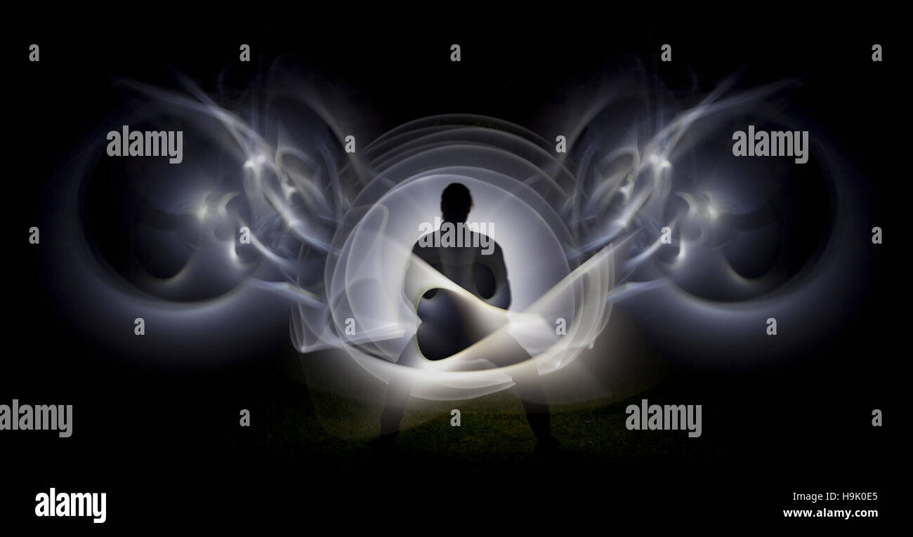 Shadow of a man painting with light Stock Photo - Alamy