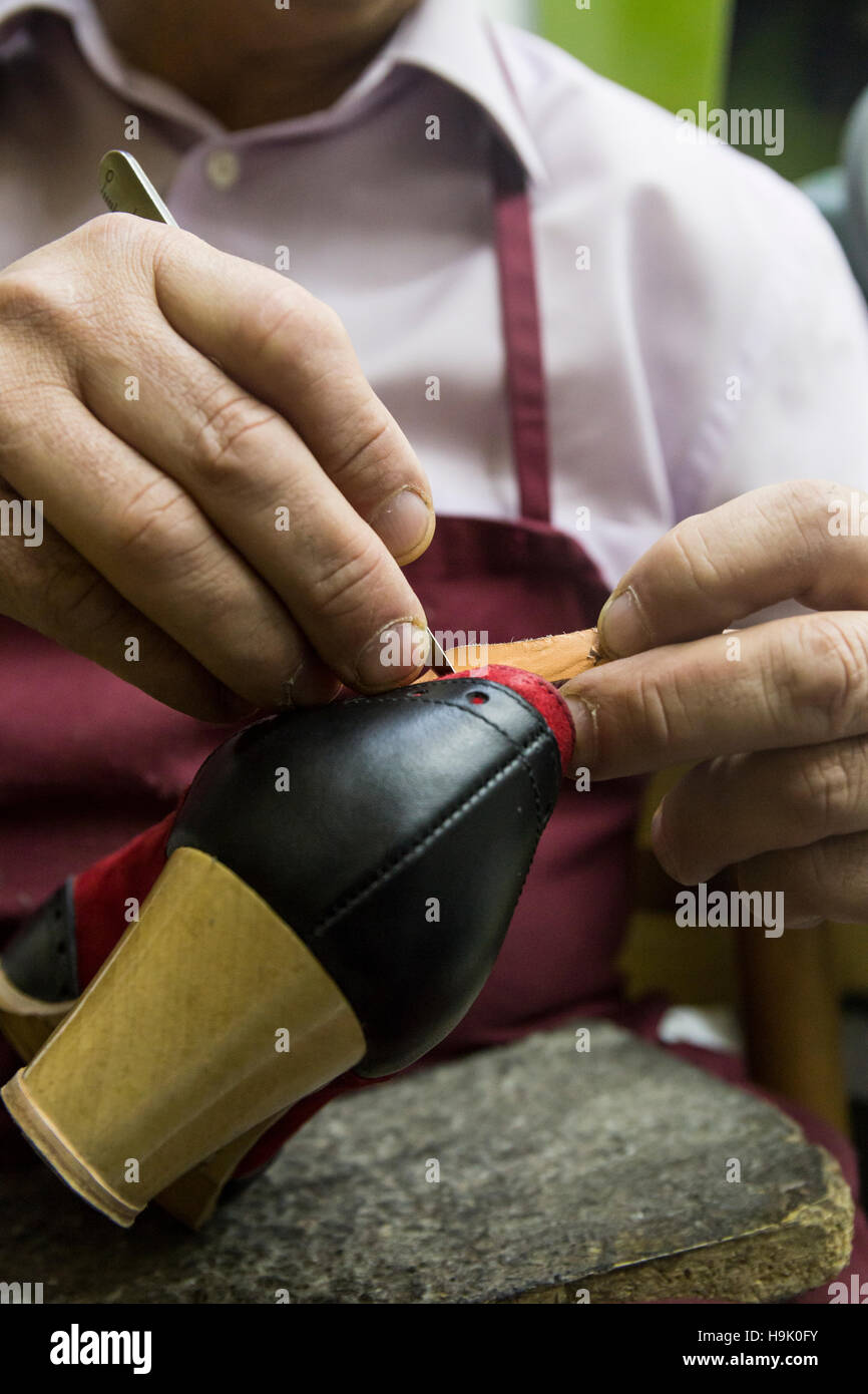 Shoemaker using a knife during a shoemaking in his workshop Stock Photo ...