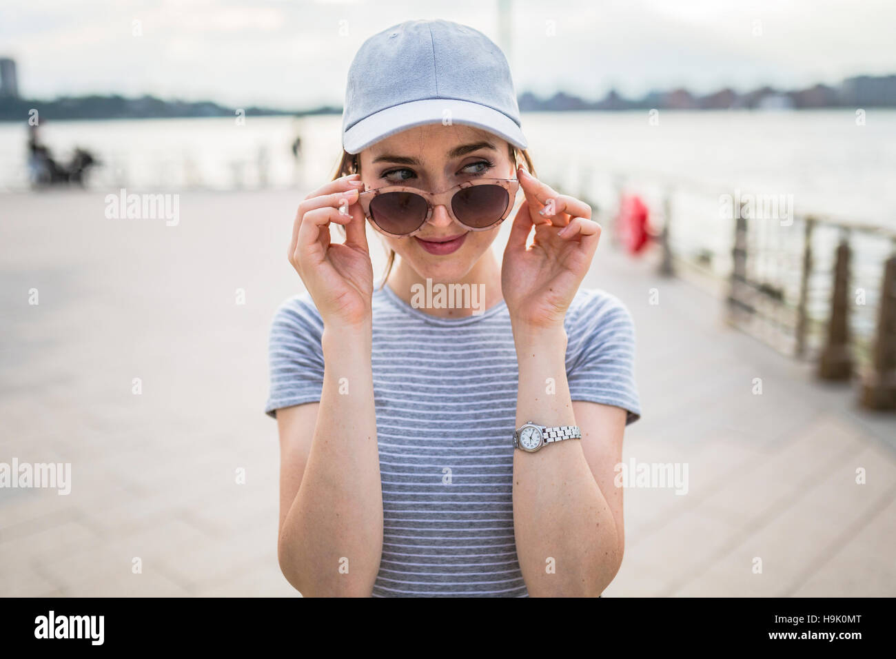 Portrait of woman with sunglasses watching something Stock Photo - Alamy