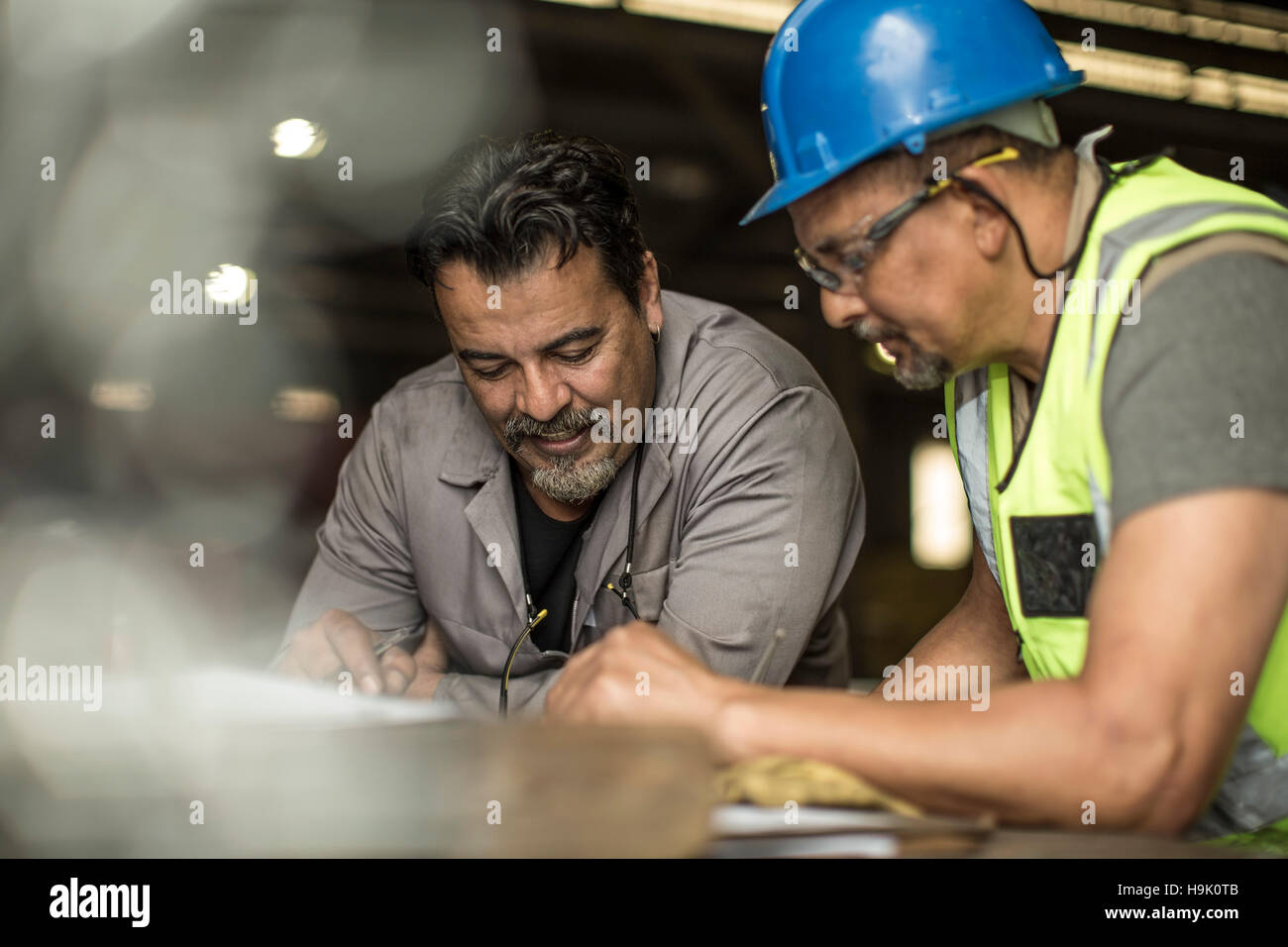 Engineers discussing construction plans Stock Photo - Alamy