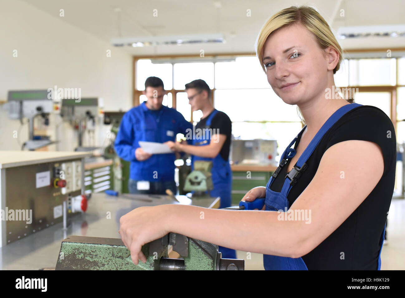 Portrait of smiling female trainee in workshop Stock Photo - Alamy