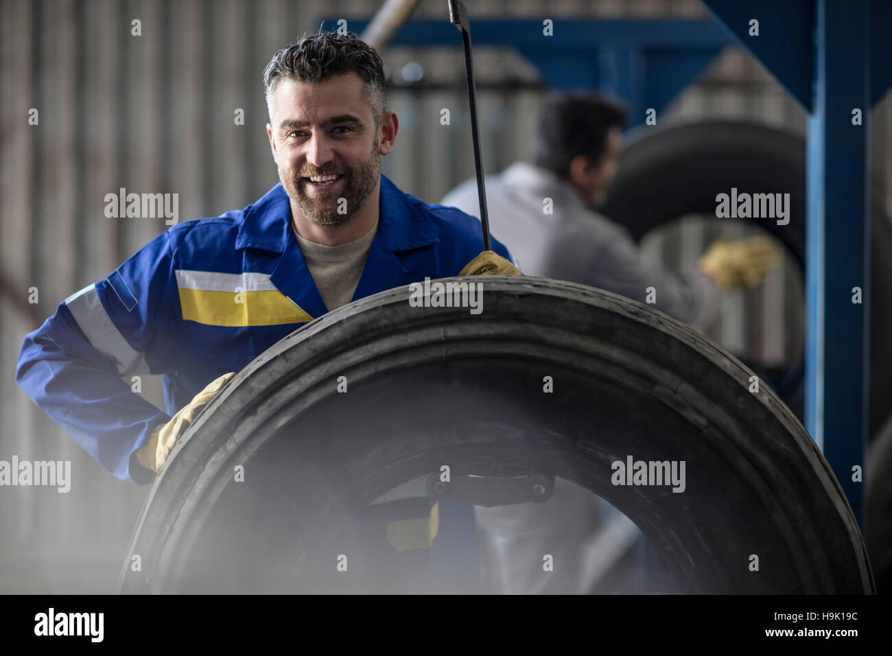 Portrait of smiling tire repairman Stock Photo - Alamy
