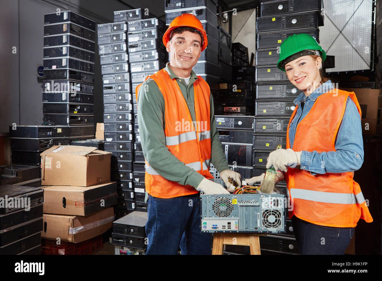 Workers in computer recycling plant cleaning pc casing Stock Photo - Alamy