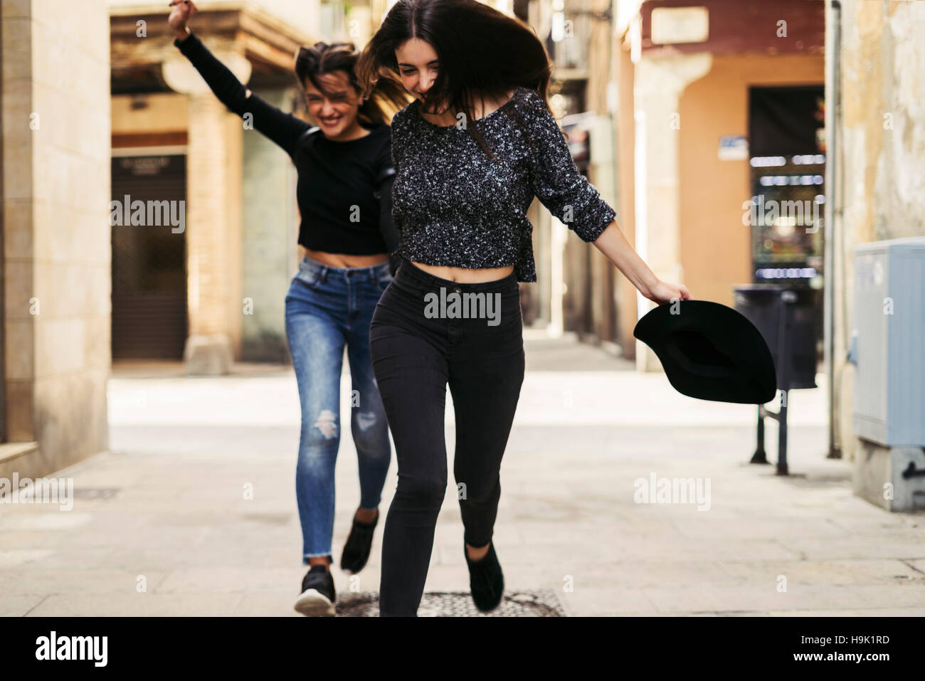 Two best friends running on the street Stock Photo - Alamy