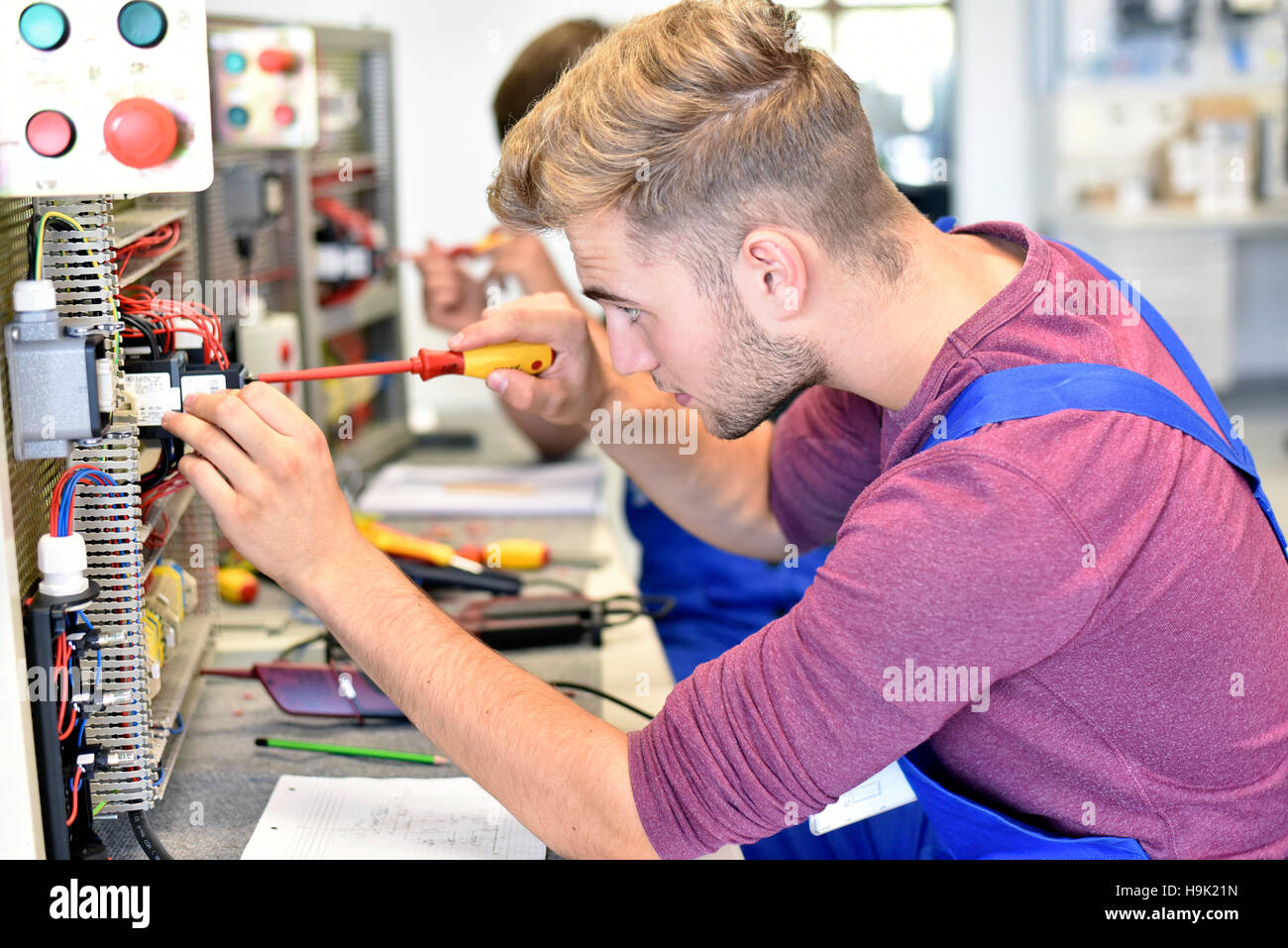 Two electrician students working at electrical panel Stock Photo - Alamy