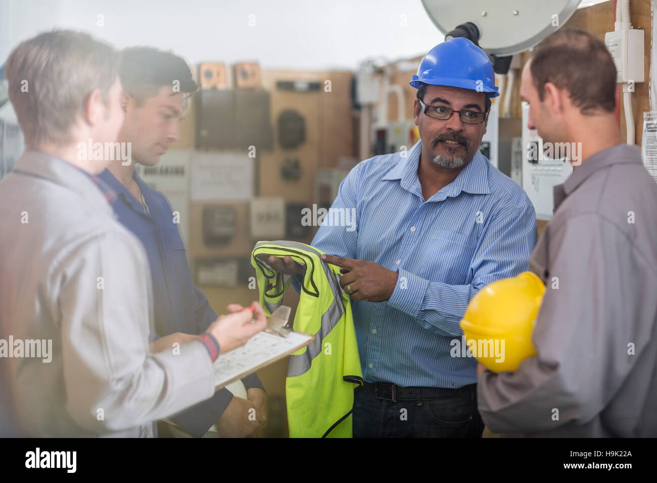 Instructor in a workshop showing safety vest Stock Photo - Alamy