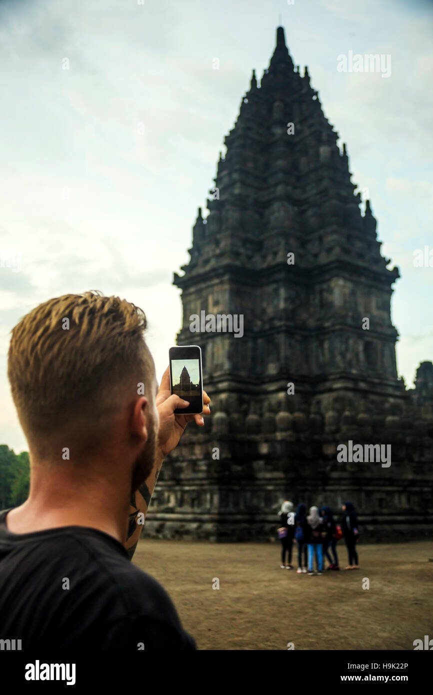 Indonesia, Java, Tourist photographing Prambanan temple Stock Photo - Alamy