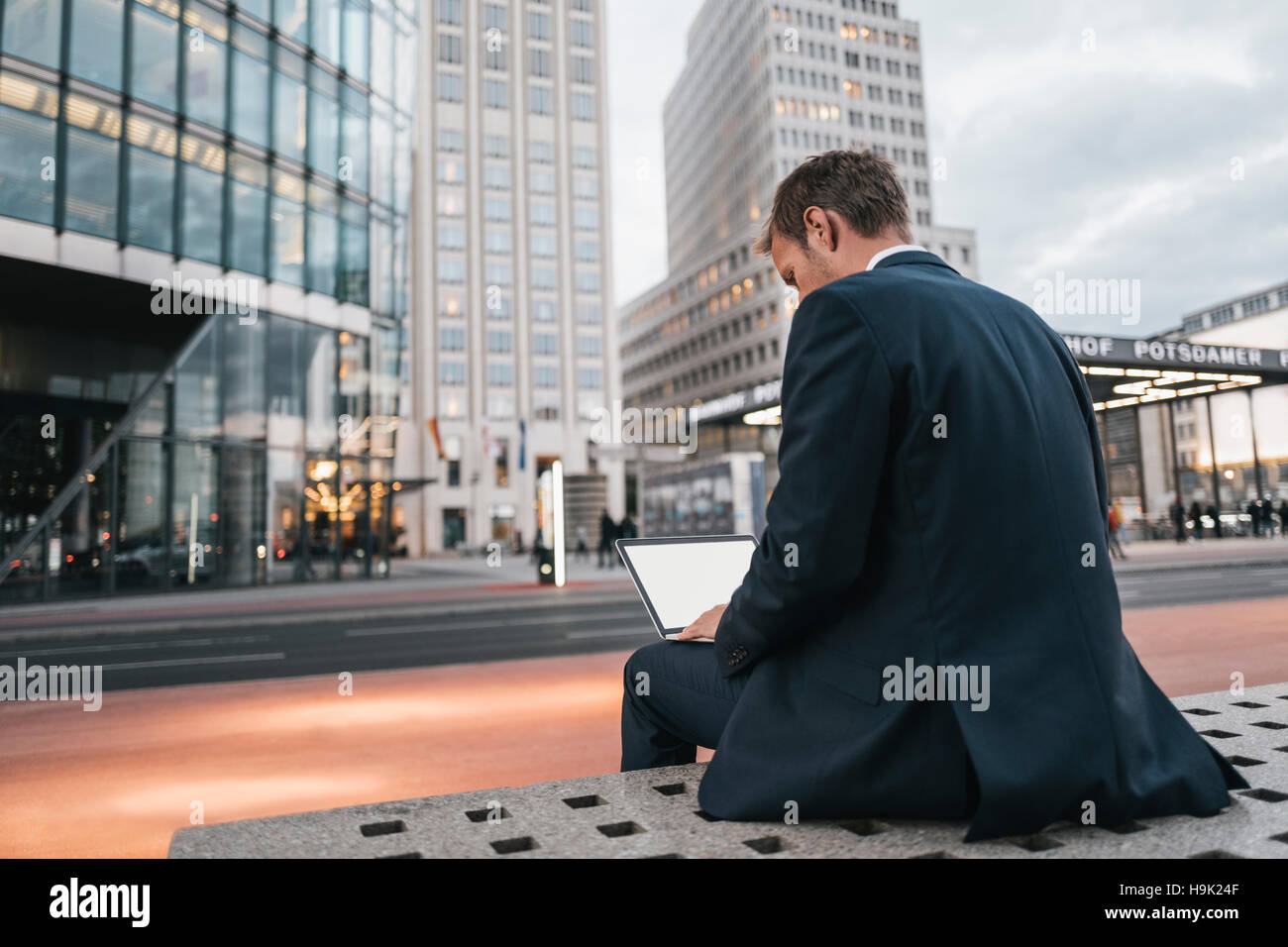 Germany, Berlin, Potsdamer Platz, Back view of businessman sitting on ...