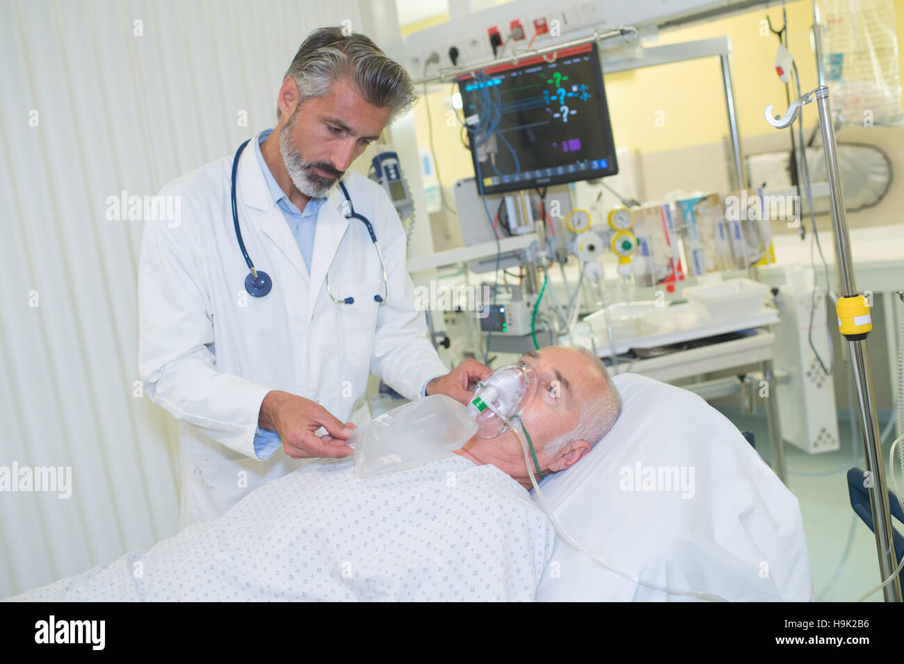 doctor taking care of critically ill patient Stock Photo - Alamy