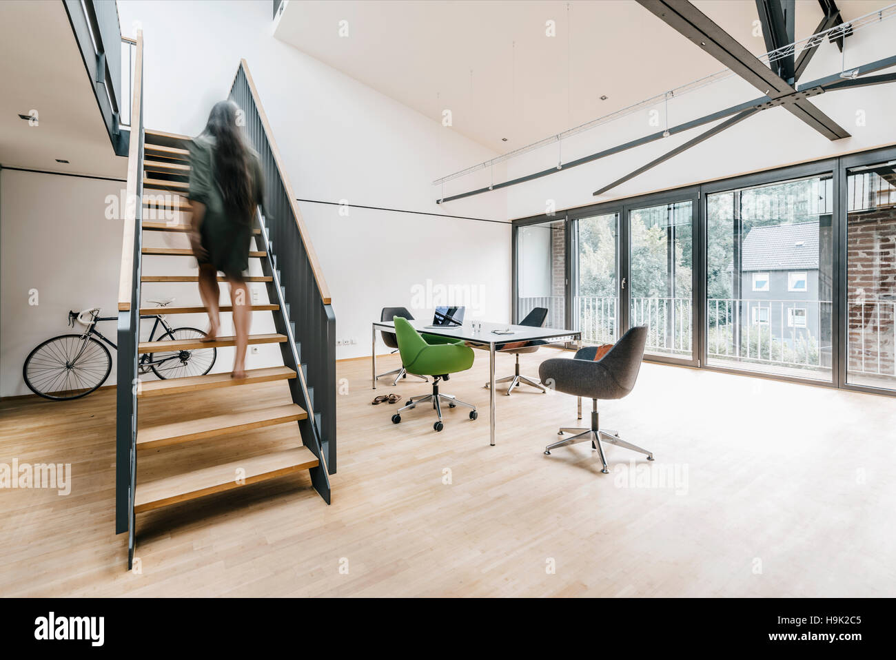 Woman on the move on stairs in office Stock Photo - Alamy