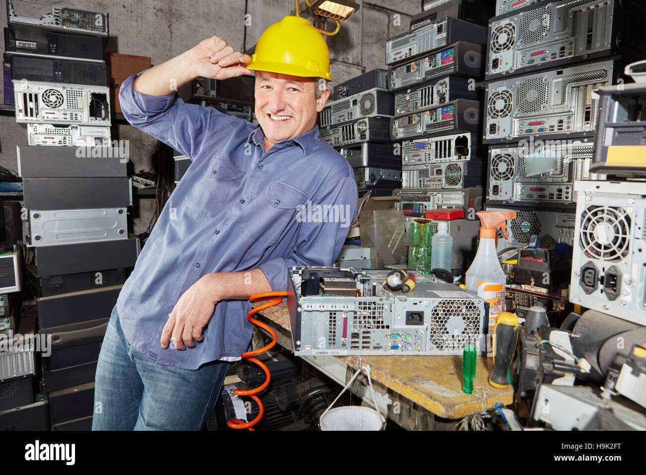 Happy worker in computer recycling plant Stock Photo - Alamy