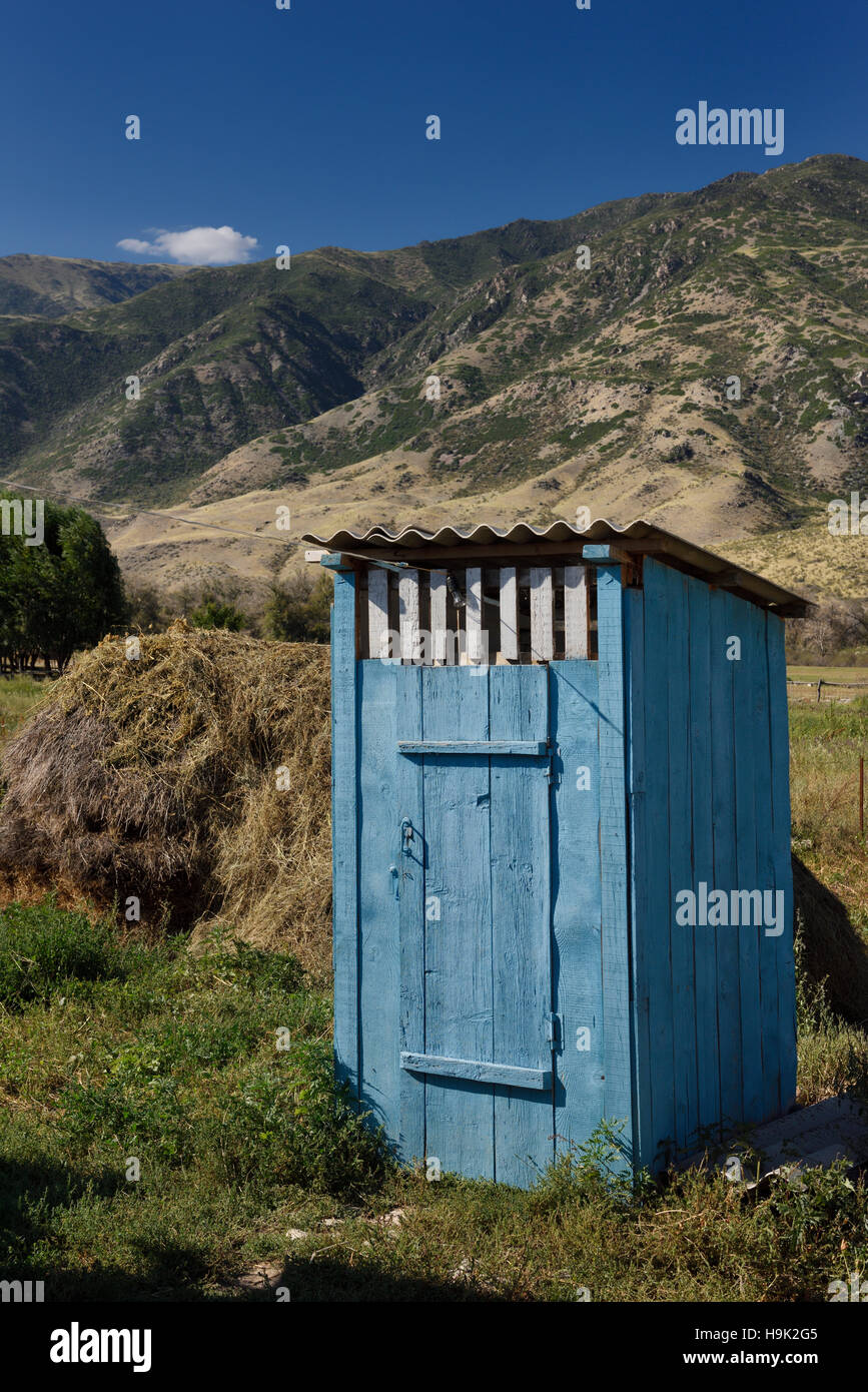 Blue outhouse with light in yard of Saty village with Kungey Alatau ...