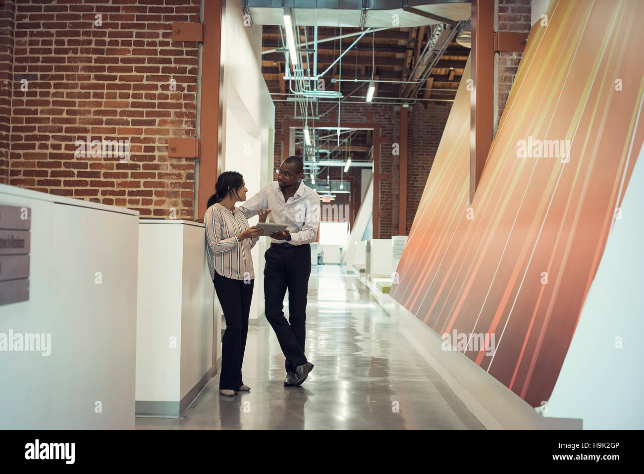 Business people talking in corridor Stock Photo - Alamy