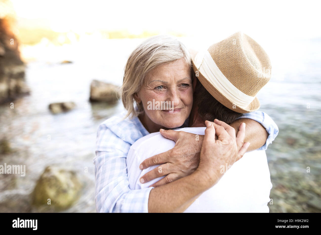 Portrait of content woman hugging her husband in front of the sea Stock ...