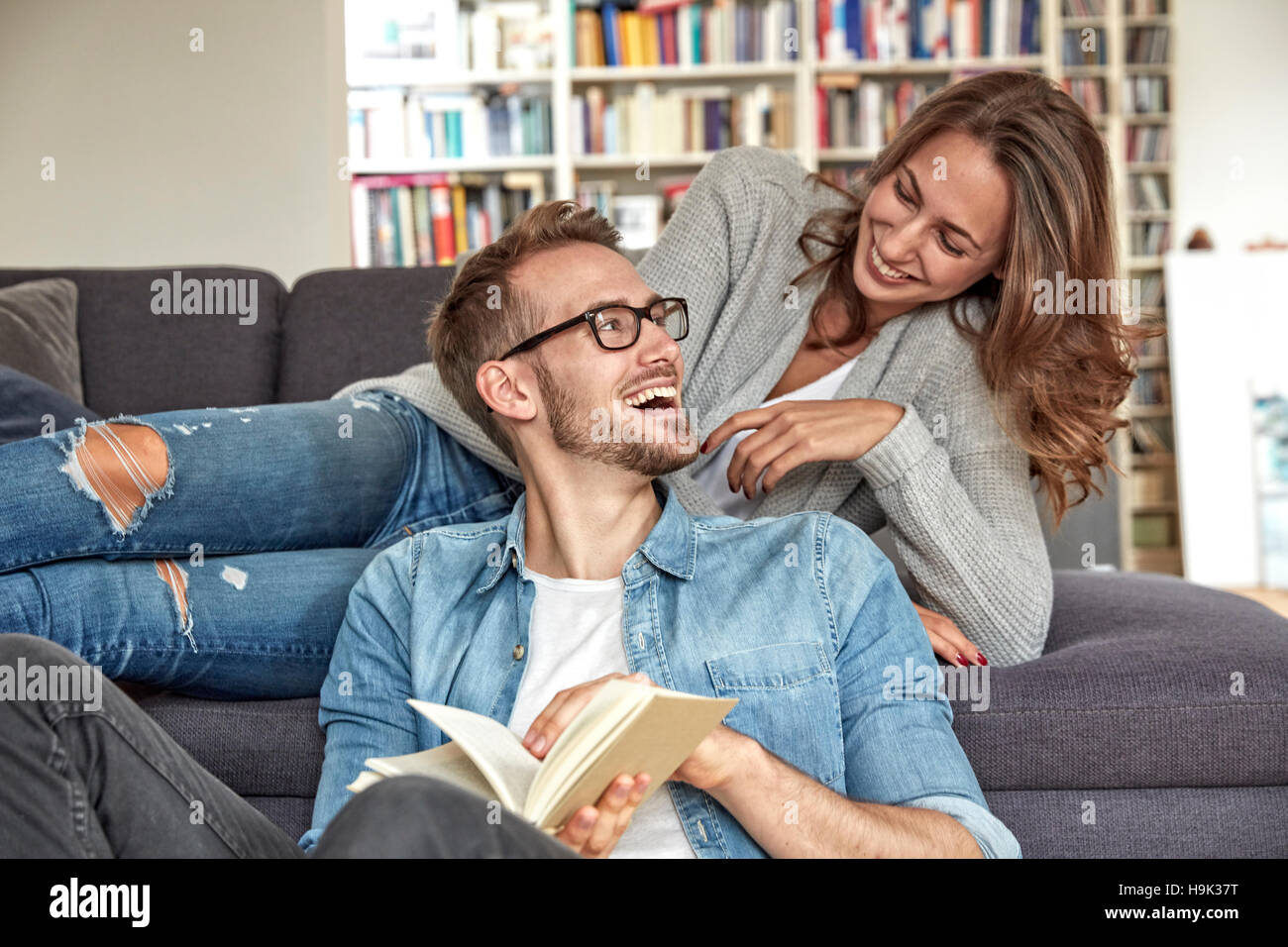 Happy couple relaxing together in the living room Stock Photo - Alamy