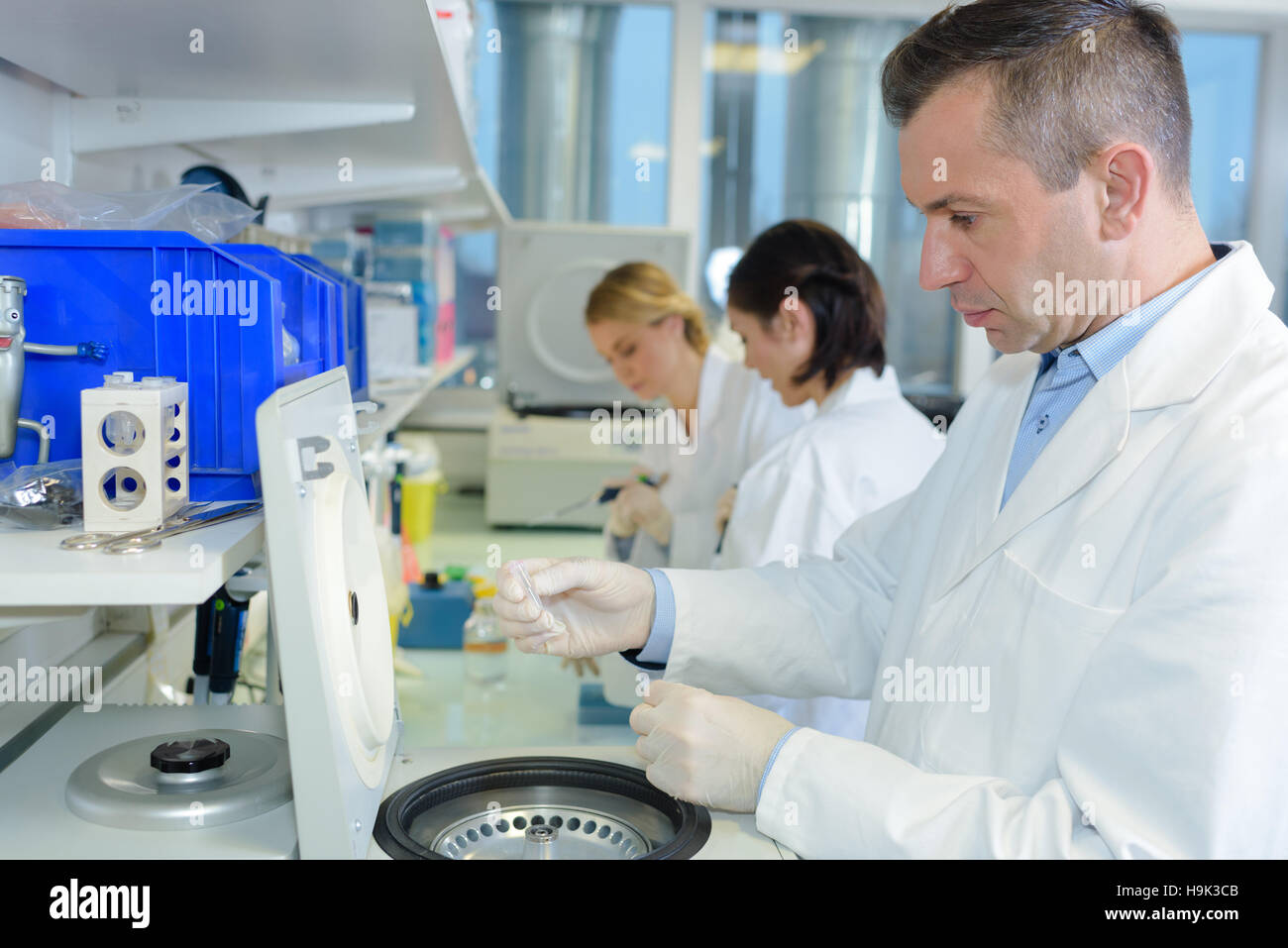 Lab technician using centrifugal machine Stock Photo - Alamy