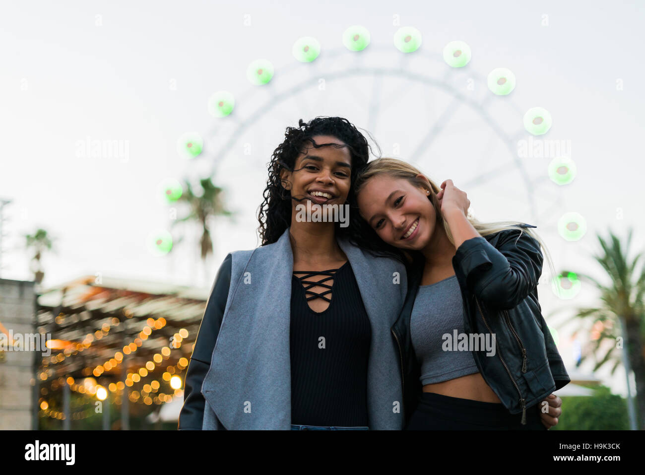 Portrait of two happy young women on a funfair Stock Photo - Alamy