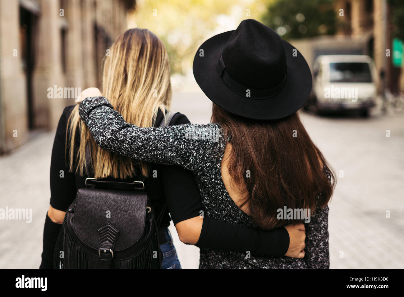 Back view of two women walking on the street Stock Photo - Alamy