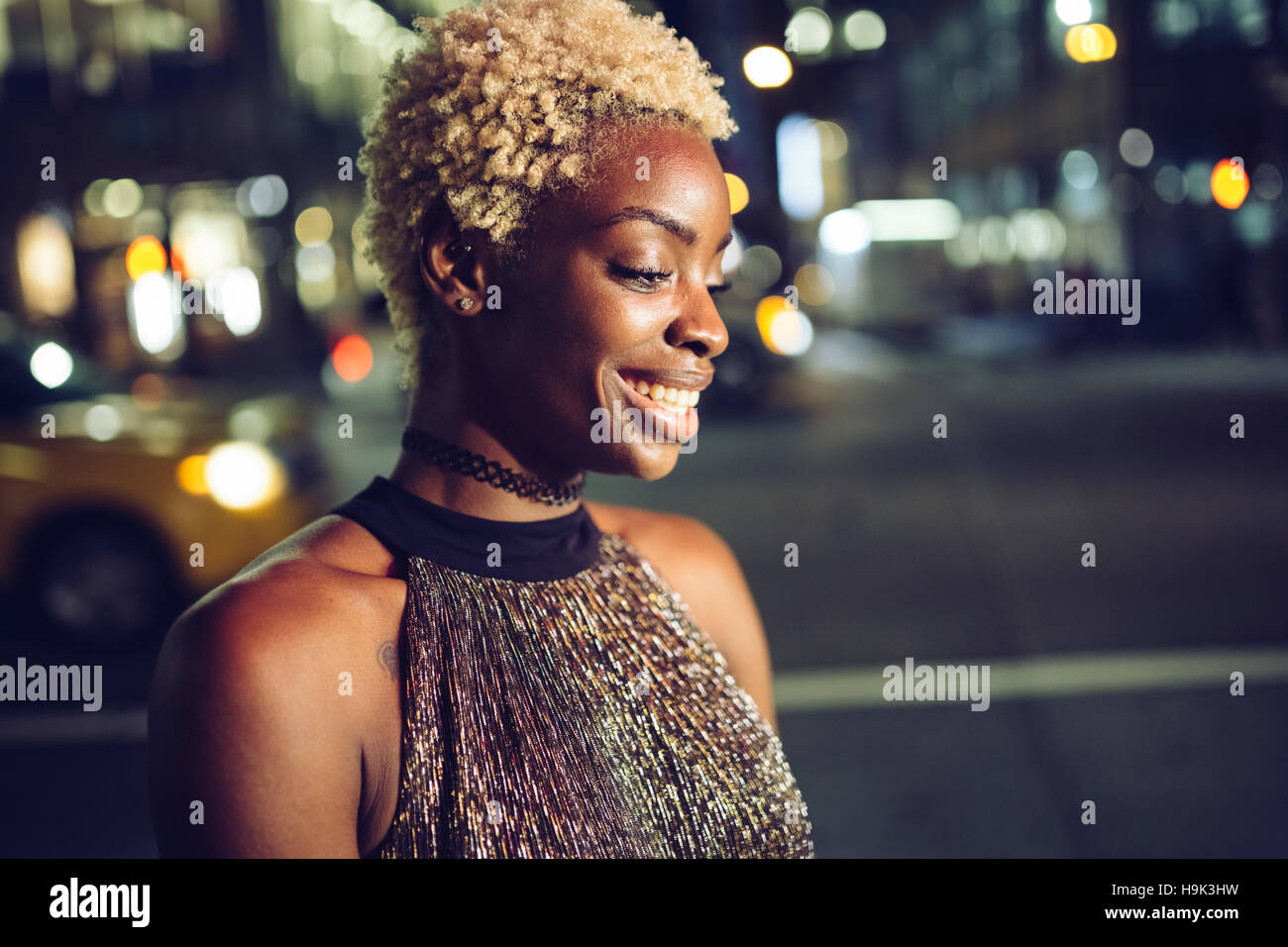 USA, New York City, portrait of happy young woman on Times Square at ...