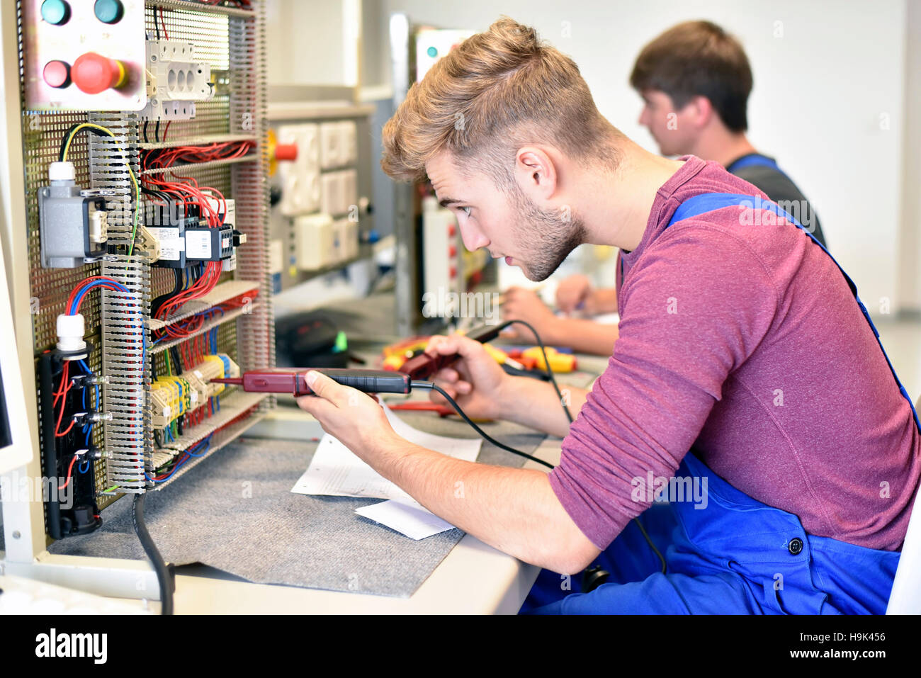 Two electrician students working at electrical panel Stock Photo - Alamy