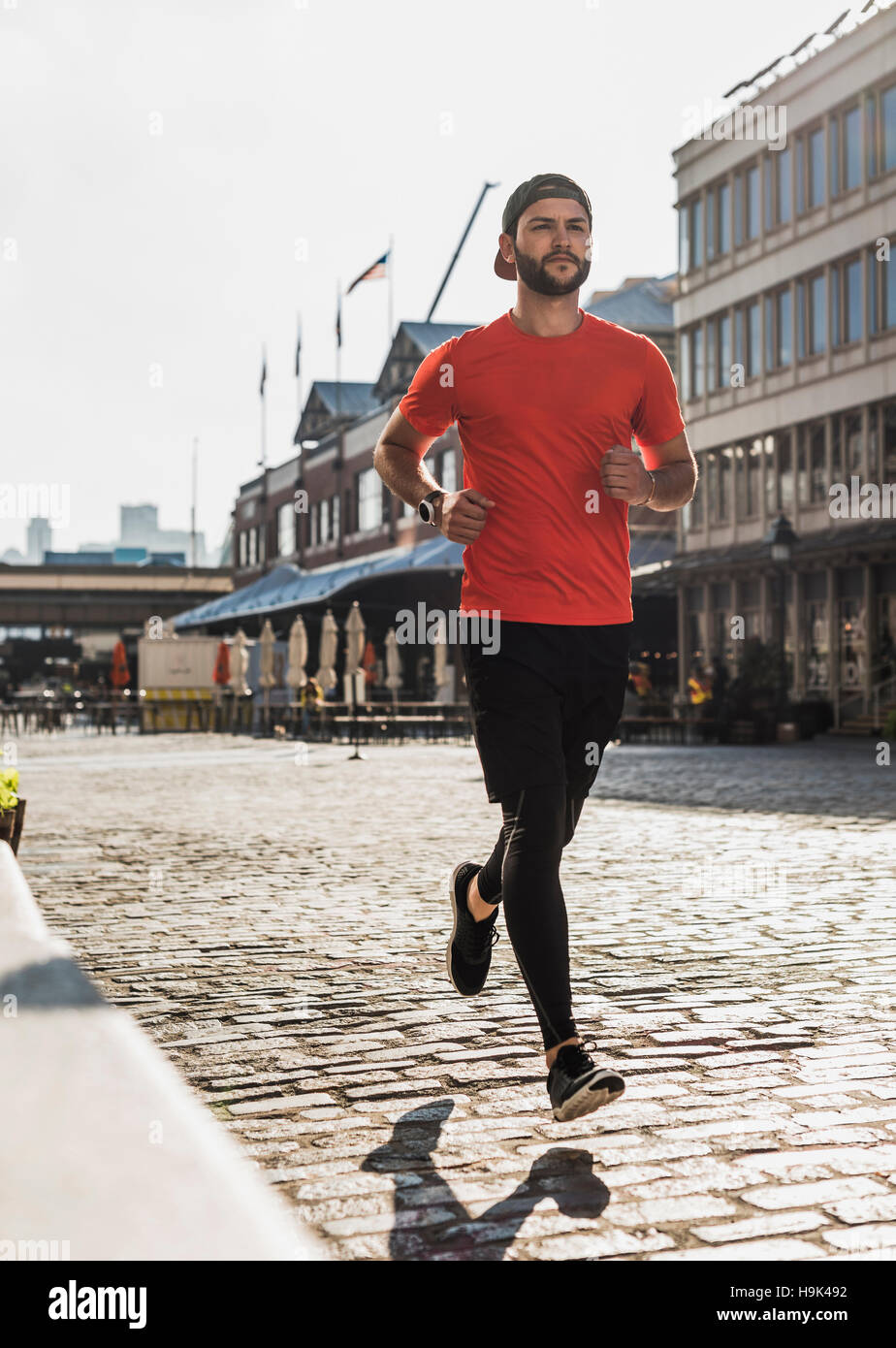 USA, New York City, man running on cobblestone pavement Stock Photo - Alamy