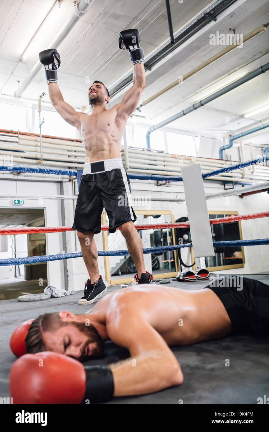 Boxer celebrating victory over his opponent Stock Photo - Alamy