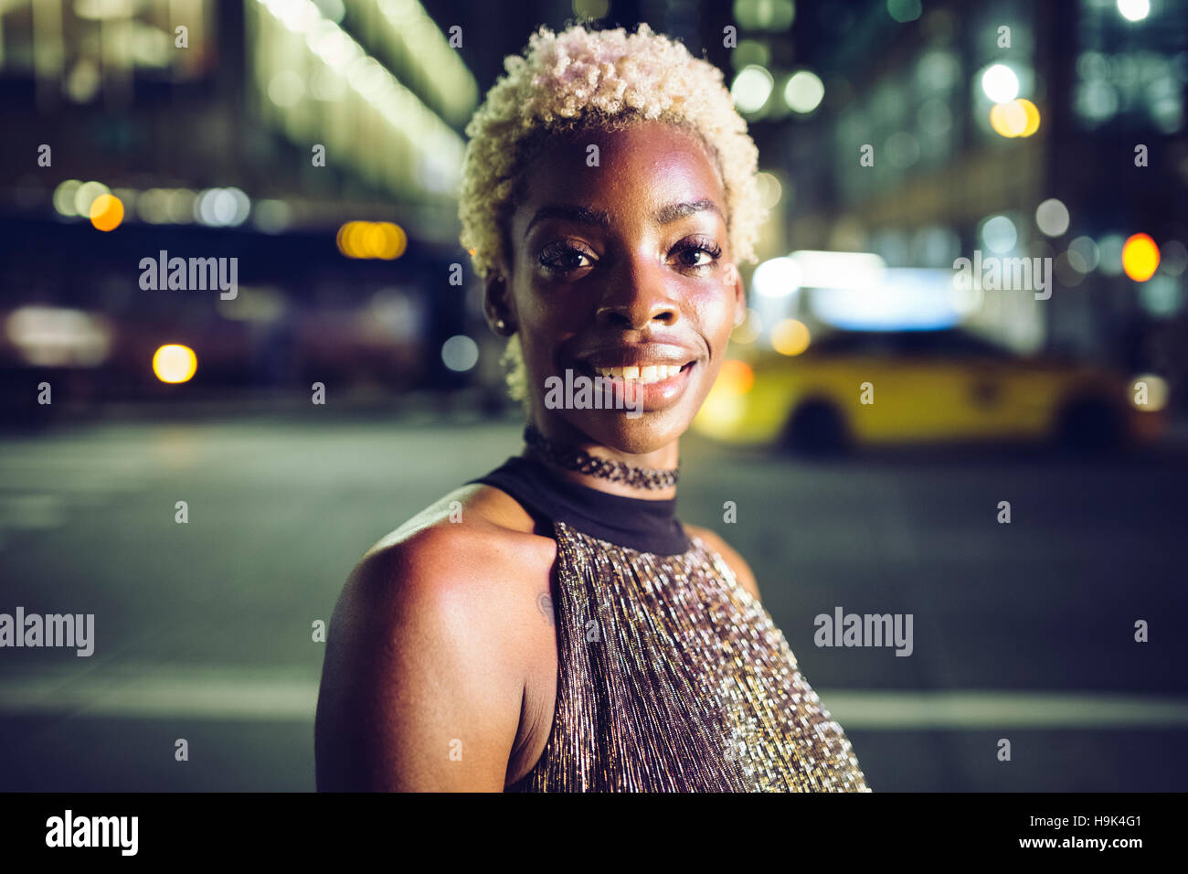 USA, New York City, portrait of happy young woman on Times Square at ...
