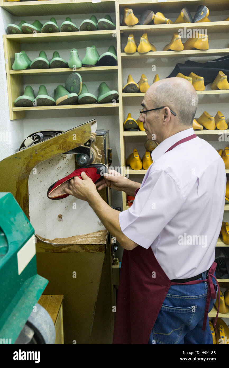 Shoemaker using a machine in his workshop Stock Photo - Alamy