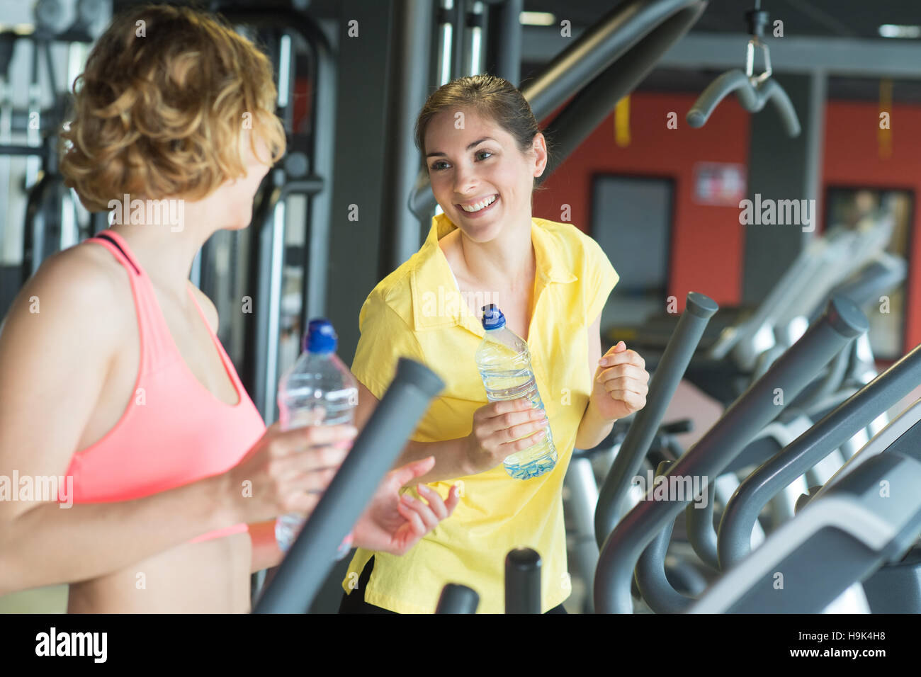 Smiling friends water bottles talking hi-res stock photography and ...