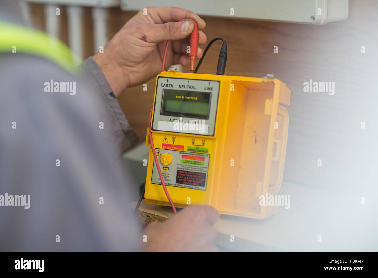 Electrician working with voltmeter Stock Photo - Alamy