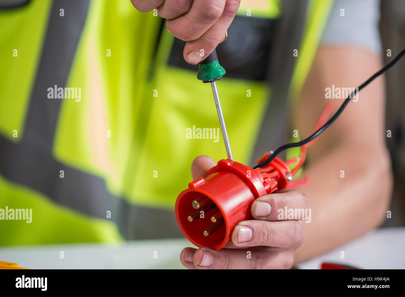 Electrician fixing connector Stock Photo - Alamy