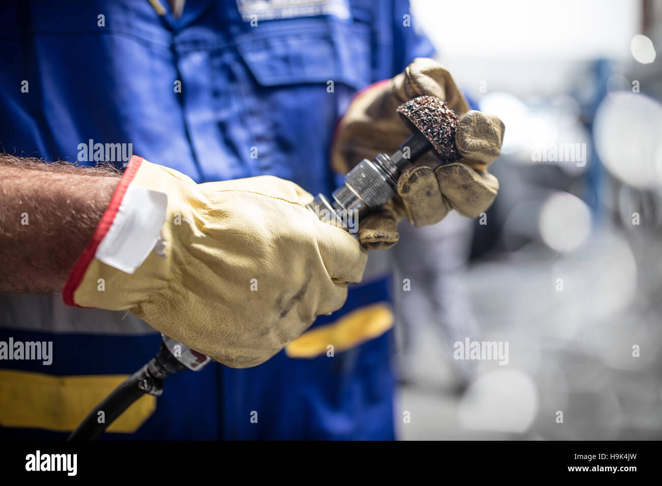 Repairman holding tire tread cutting machine Stock Photo - Alamy