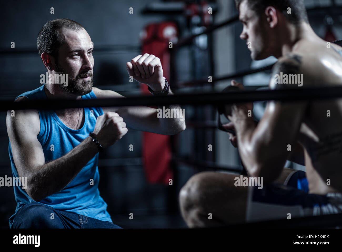 Coach with boxer in boxing ring Stock Photo - Alamy