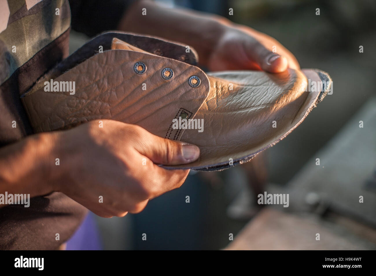 Shoemaker working on shoe in workshop Stock Photo - Alamy