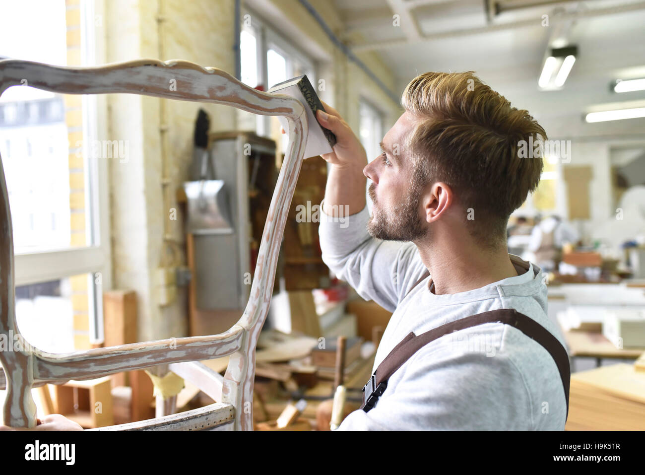 Carpenter restoring a wooden chair Stock Photo - Alamy