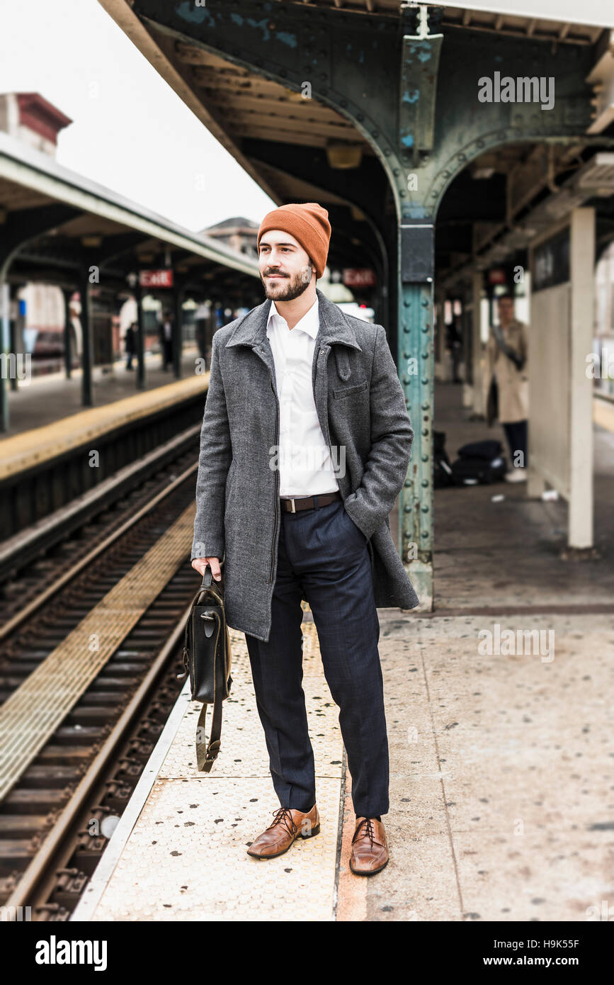 Young man waiting at metro station platform Stock Photo - Alamy