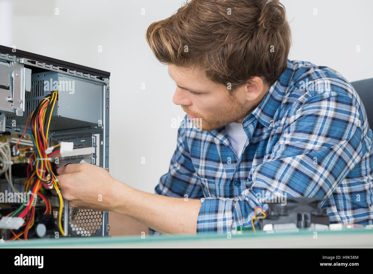 young man fixing computer Stock Photo - Alamy