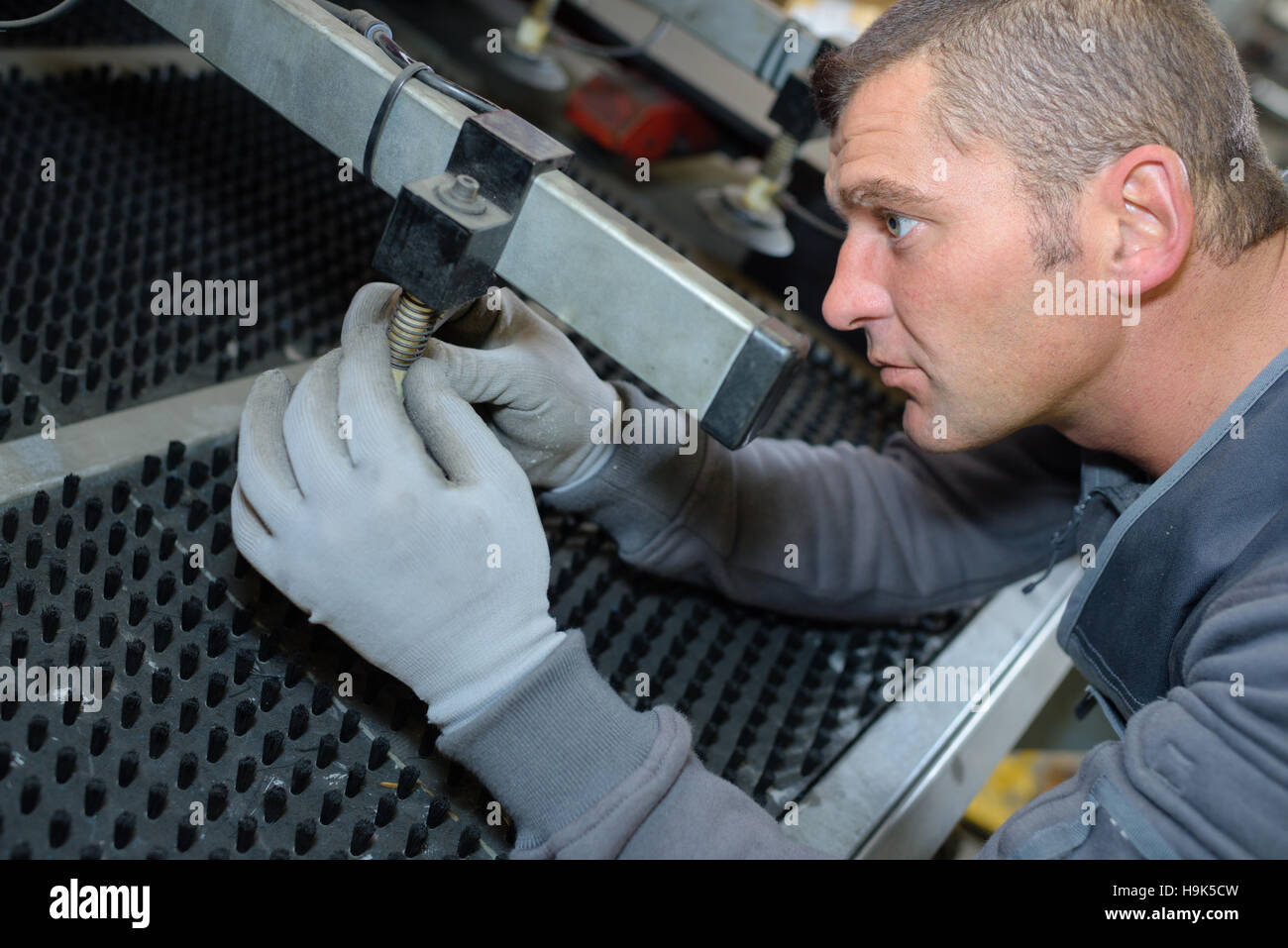 Man setting up industrial machine Stock Photo - Alamy