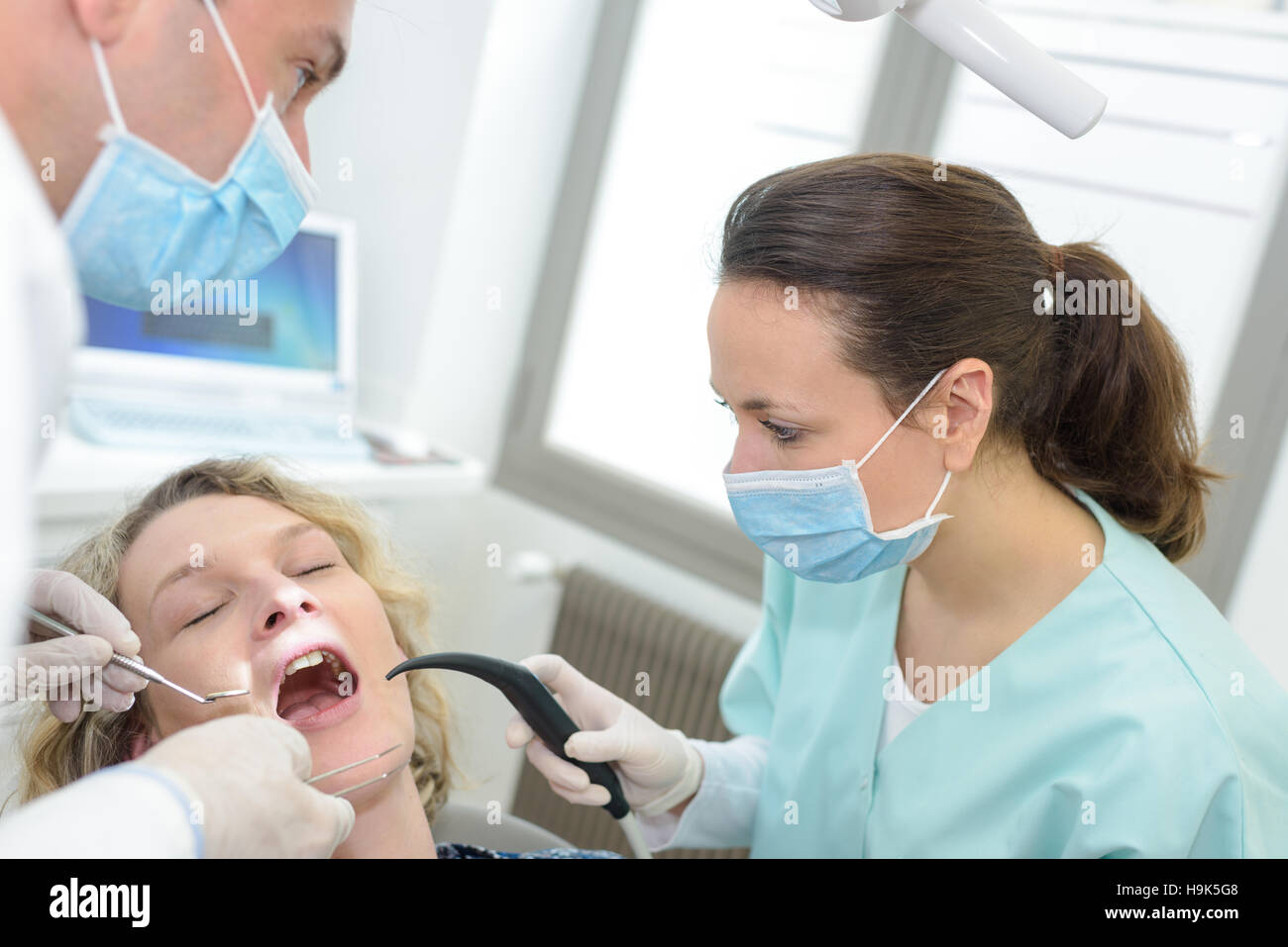 dentist curing a female patient Stock Photo - Alamy