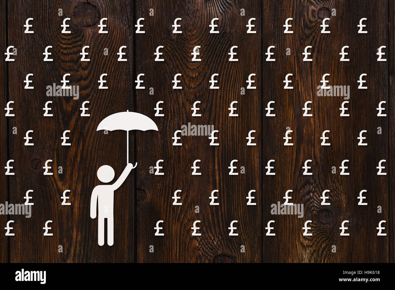 Man with umbrella standing, rain of pound sterlings, money concept ...
