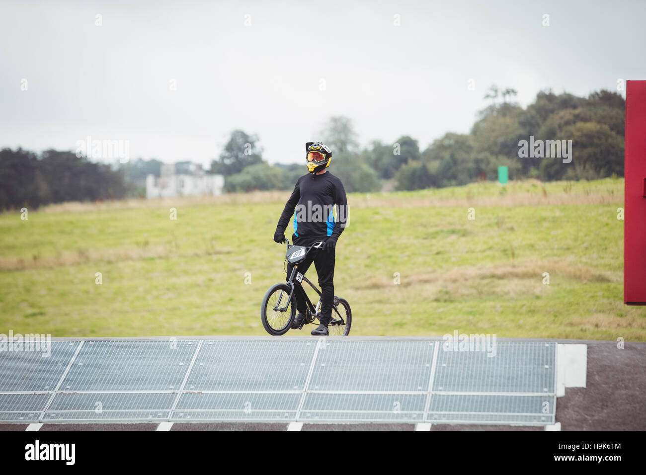 Cyclist standing with BMX bike at starting ramp Stock Photo - Alamy