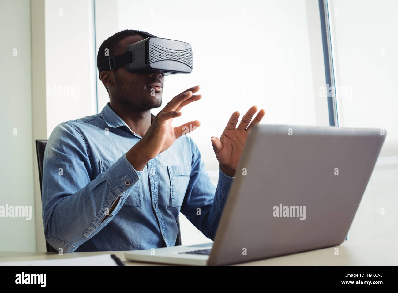 Business executive using virtual reality headset Stock Photo - Alamy