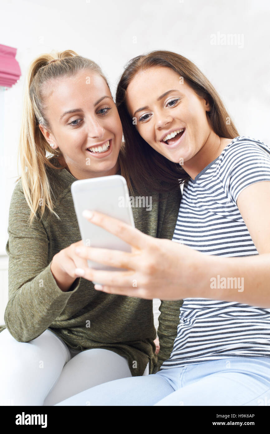 Teenage Girls Reading Text Message On Mobile Phone Stock Photo - Alamy