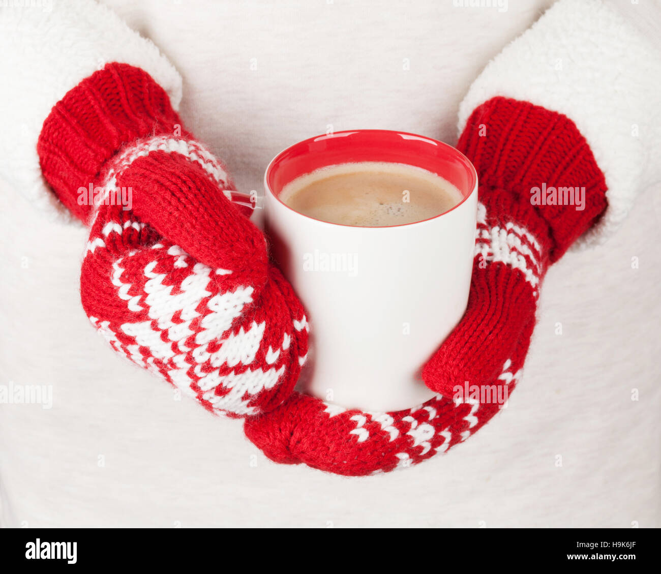 Female hands holding hot chocolate in red mittens Stock Photo - Alamy