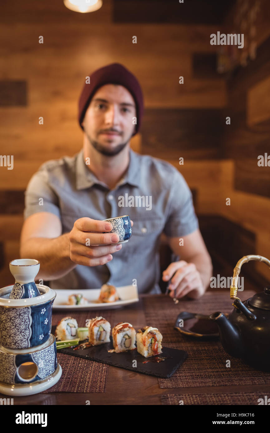 Portrait of man showing cup Stock Photo - Alamy