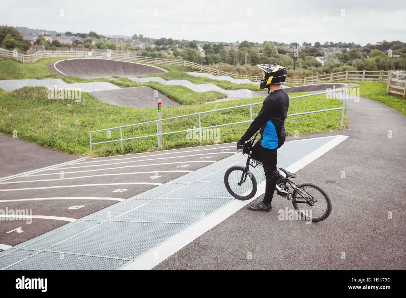 Cyclist standing with BMX bike on starting ramp Stock Photo - Alamy