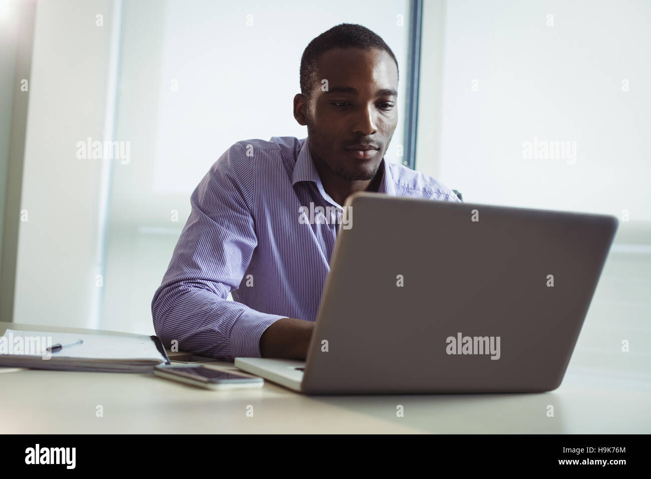 Business executive using laptop Stock Photo - Alamy