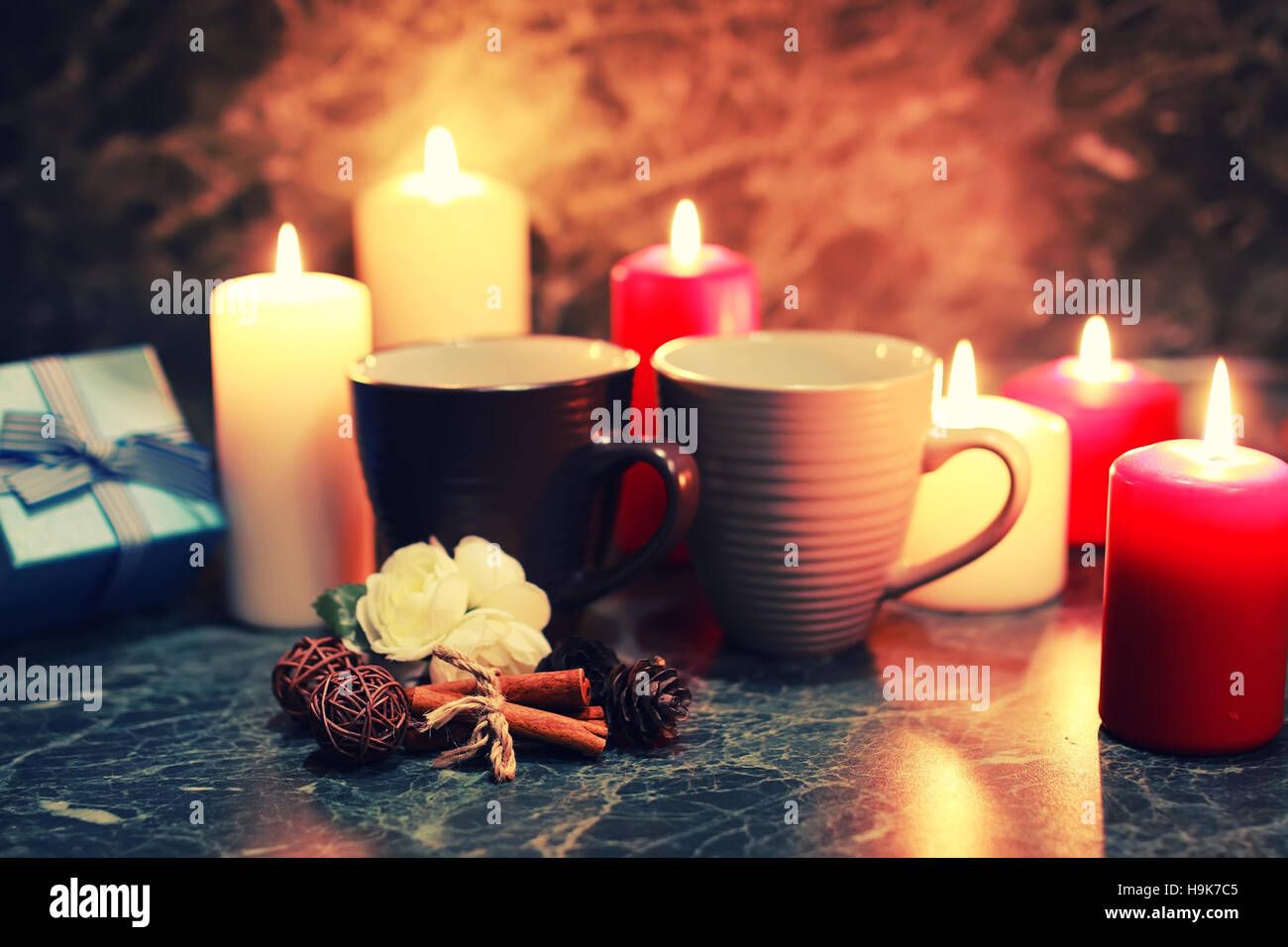 night table with mug and candle Stock Photo - Alamy